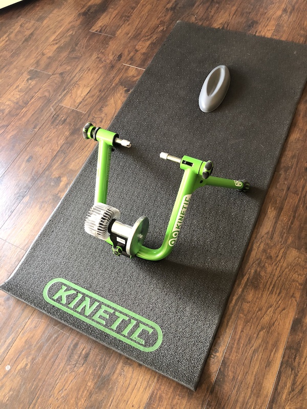 Kinetic Road Machine Trainer with Mat and Wheel Riser For Sale